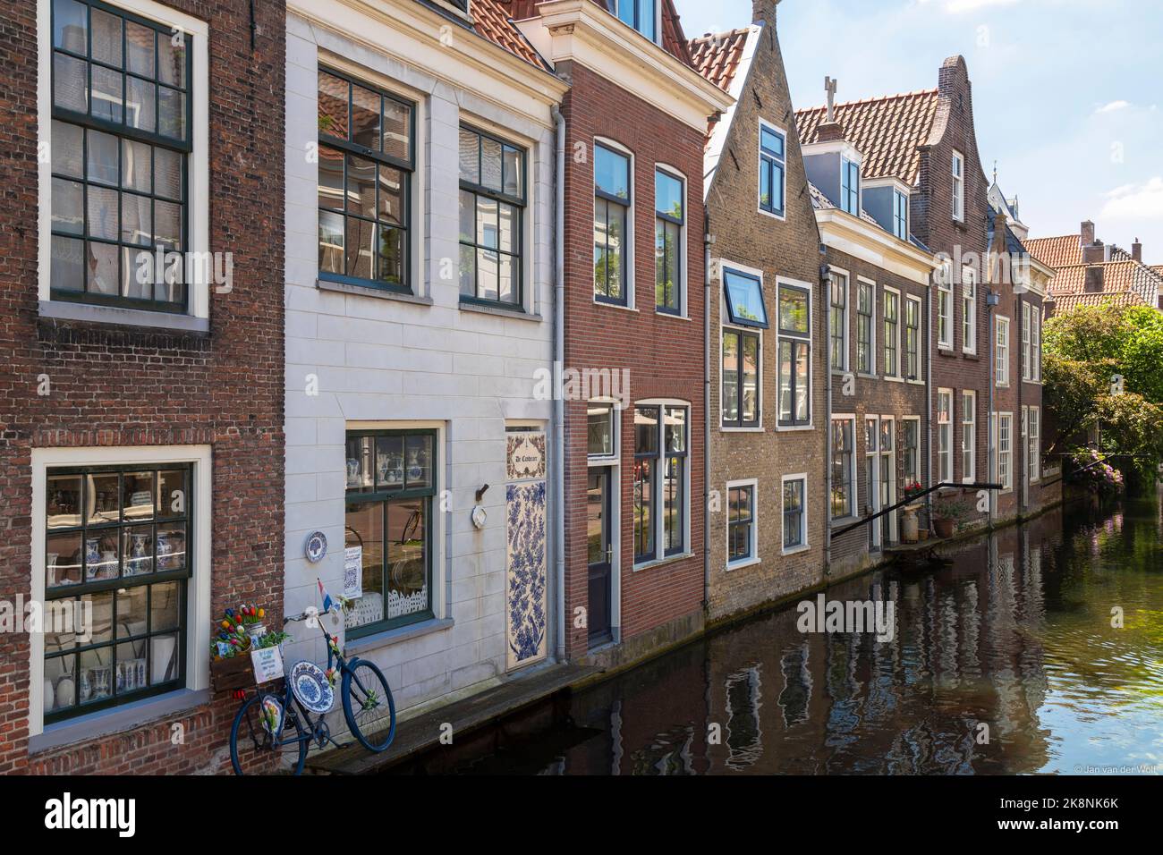 Historic houses along the canal in the medieval city of Delft in the ...