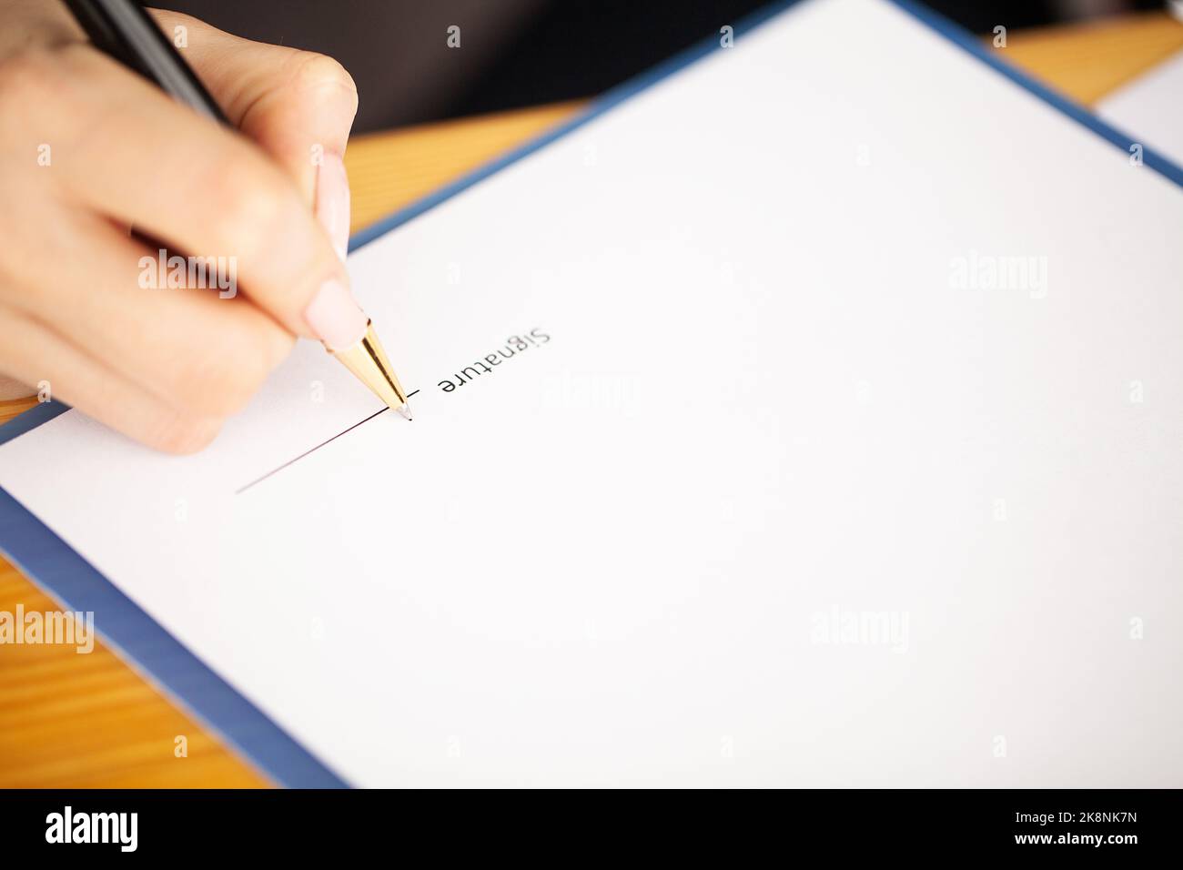 Blank of paper is on a wooden desk. Blank a4 paper is in the middle of ...