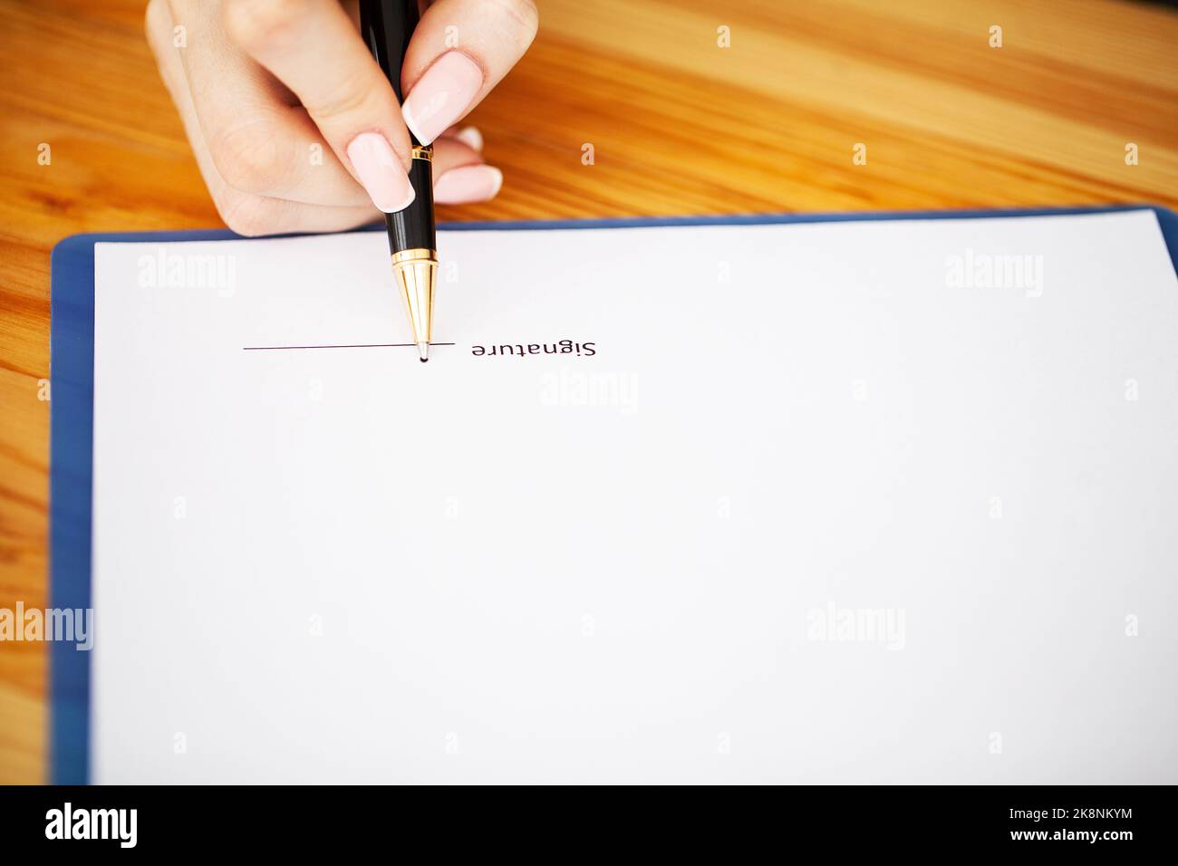 Blank of paper is on a wooden desk. Blank a4 paper is in the middle of ...