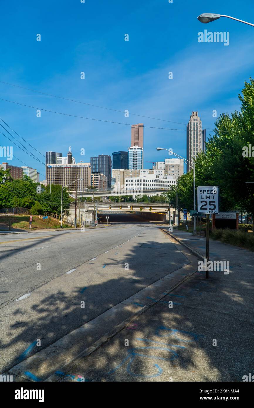 An asphalt road and skyscrapers with Georgia State University under the ...