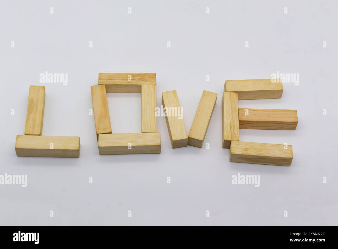 The word LOVE written by the wooden blocks against white background ...