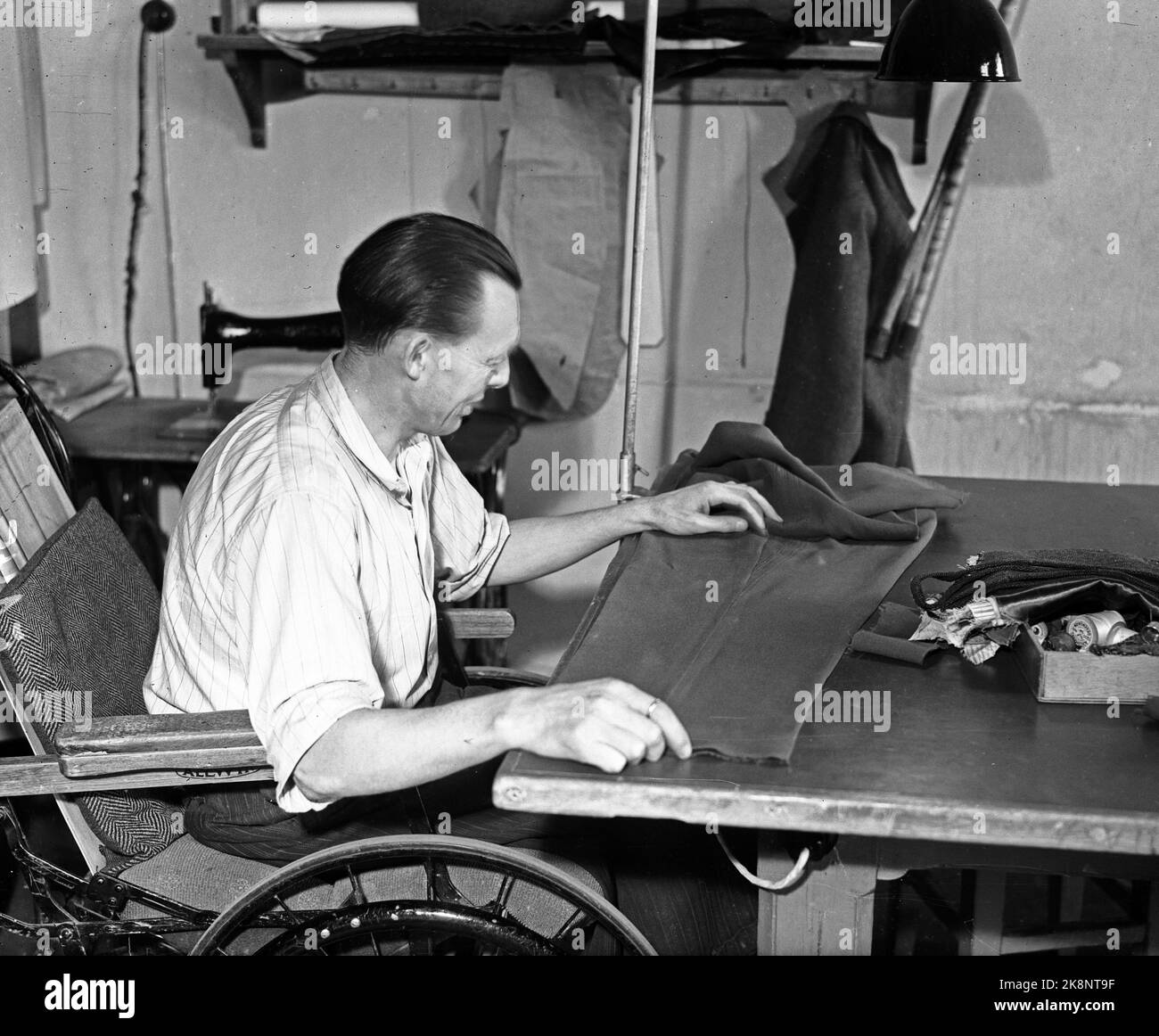 WW2 Oslo 19440418 Sophies Minde. A disabled man is working on a trouser ...