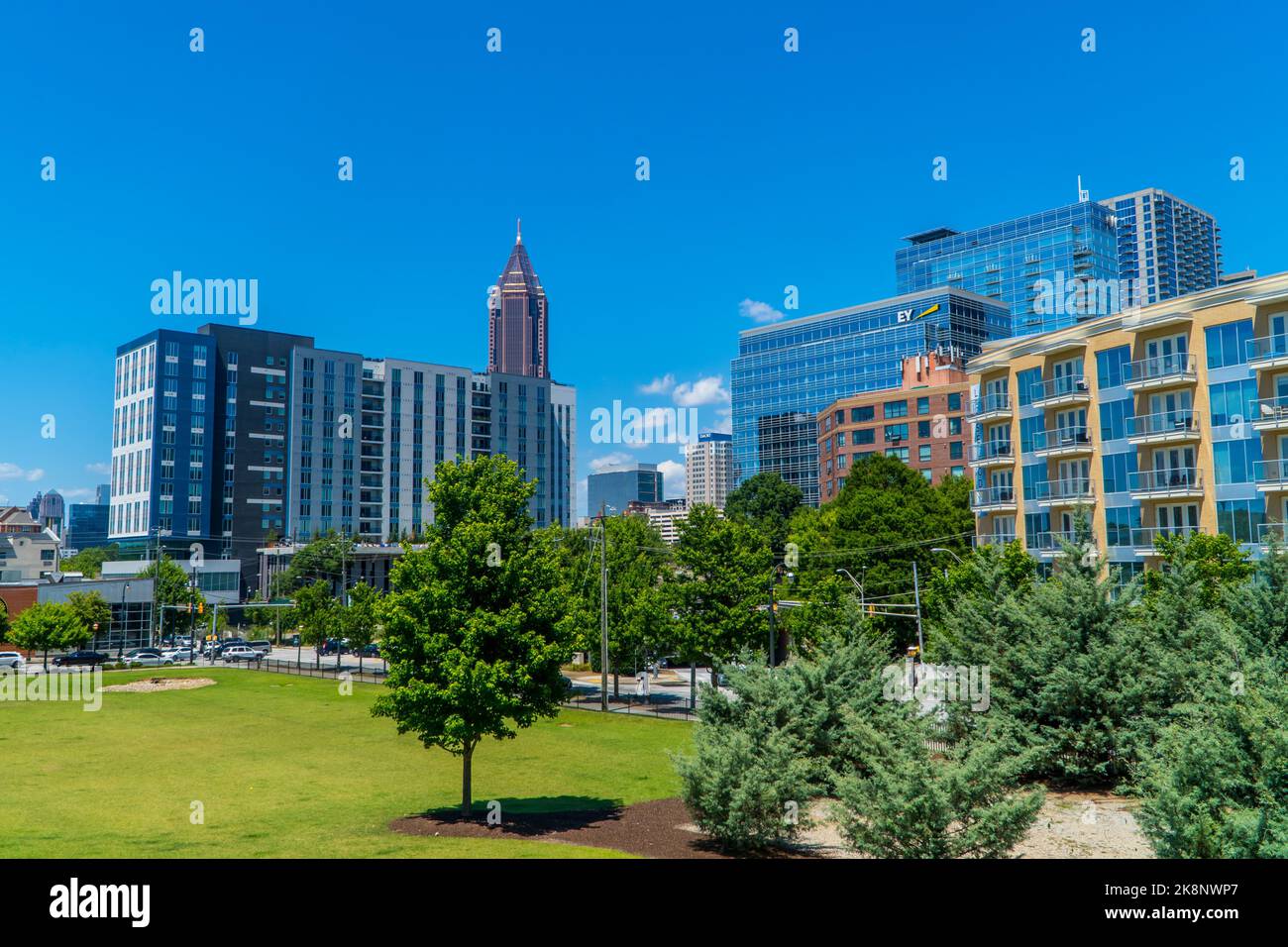 A scenic view of modern office buildings with a green park in downtown ...