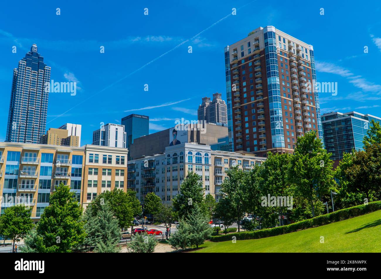 A scenic view of modern office buildings with a green park in downtown ...