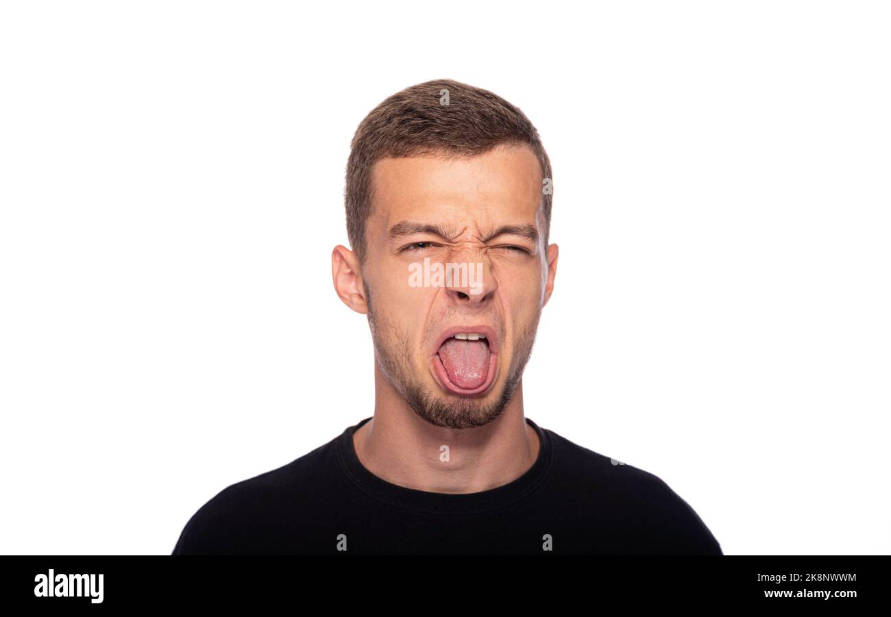 A young man and makes a disgusted grimace on a white Stock Photo - Alamy
