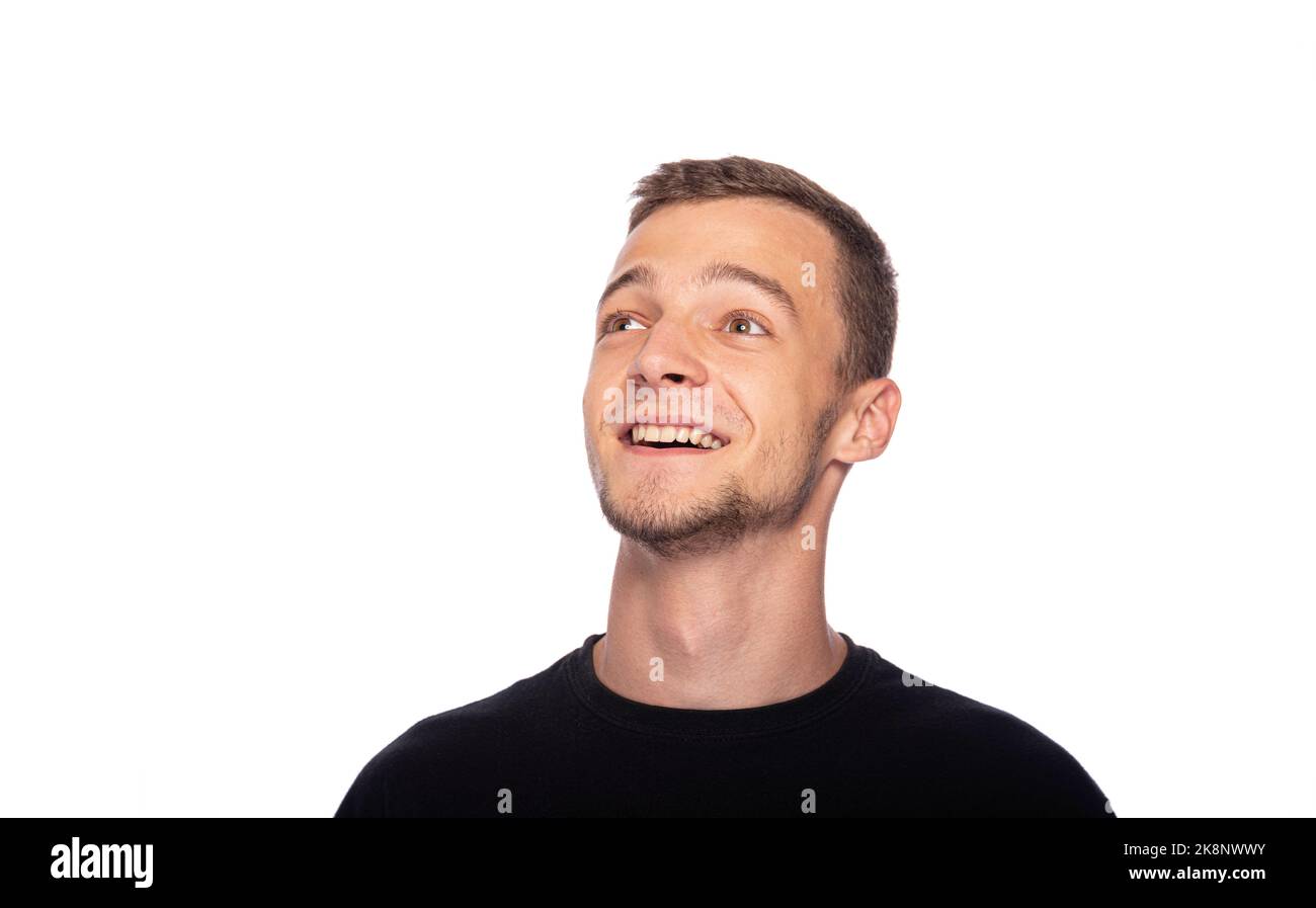 A young man looks up on a white background Stock Photo - Alamy