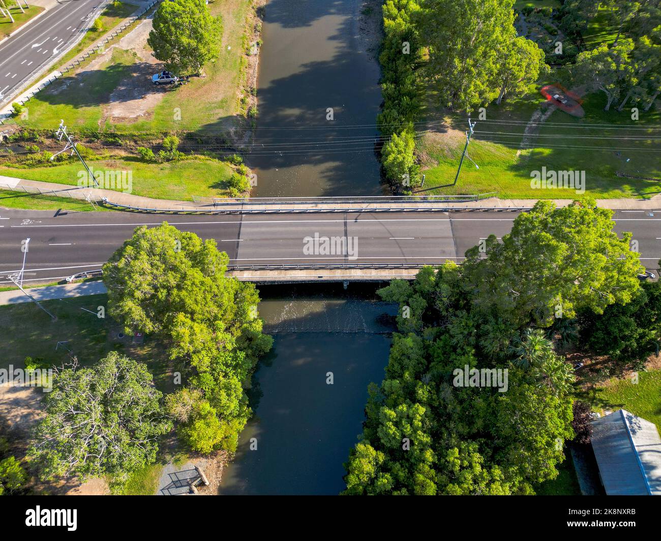 Aerial downward shot of tropical river bridge crossing in Far north ...