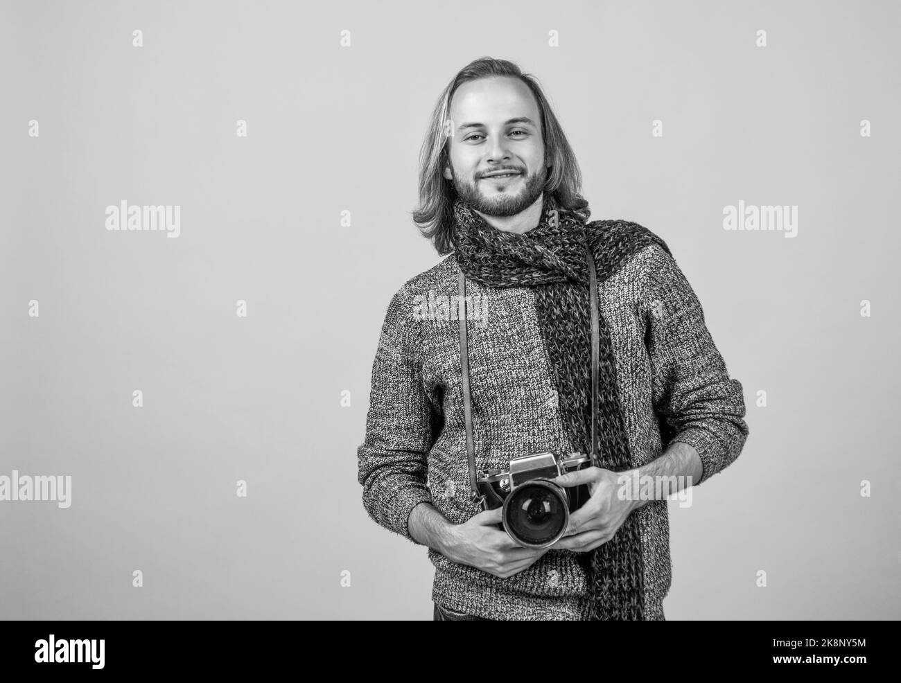 A true shutterbug. Photographer yellow background. Photographer hold ...