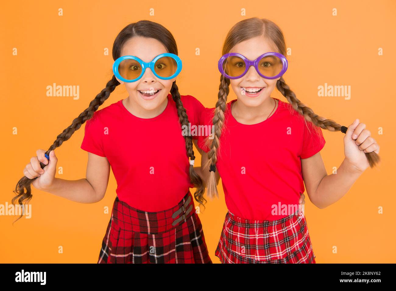 Summer accessory. Girls cute sisters similar outfits wear colorful ...