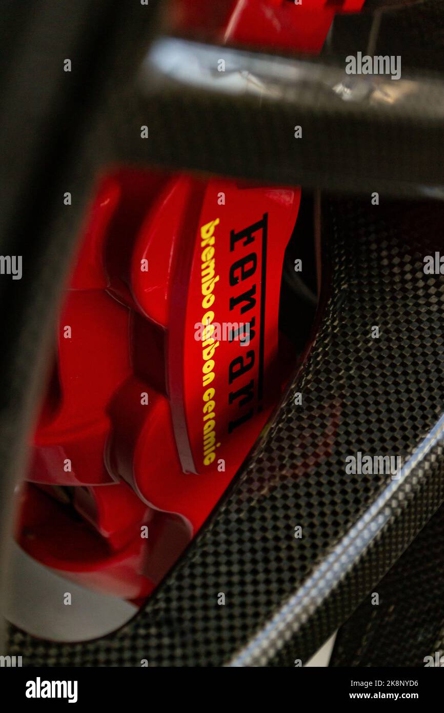 a closeup of Ferrari 488 Pista Red brake calipers behind carbon wheel ...
