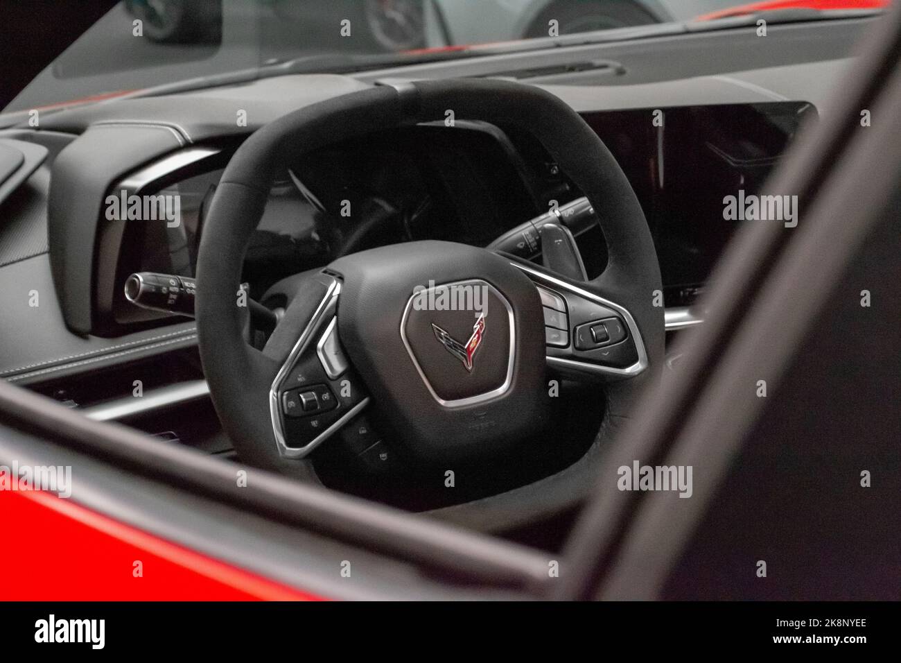 a closeup of a wheel of red Corvette Stingray C8 car from outside Stock ...