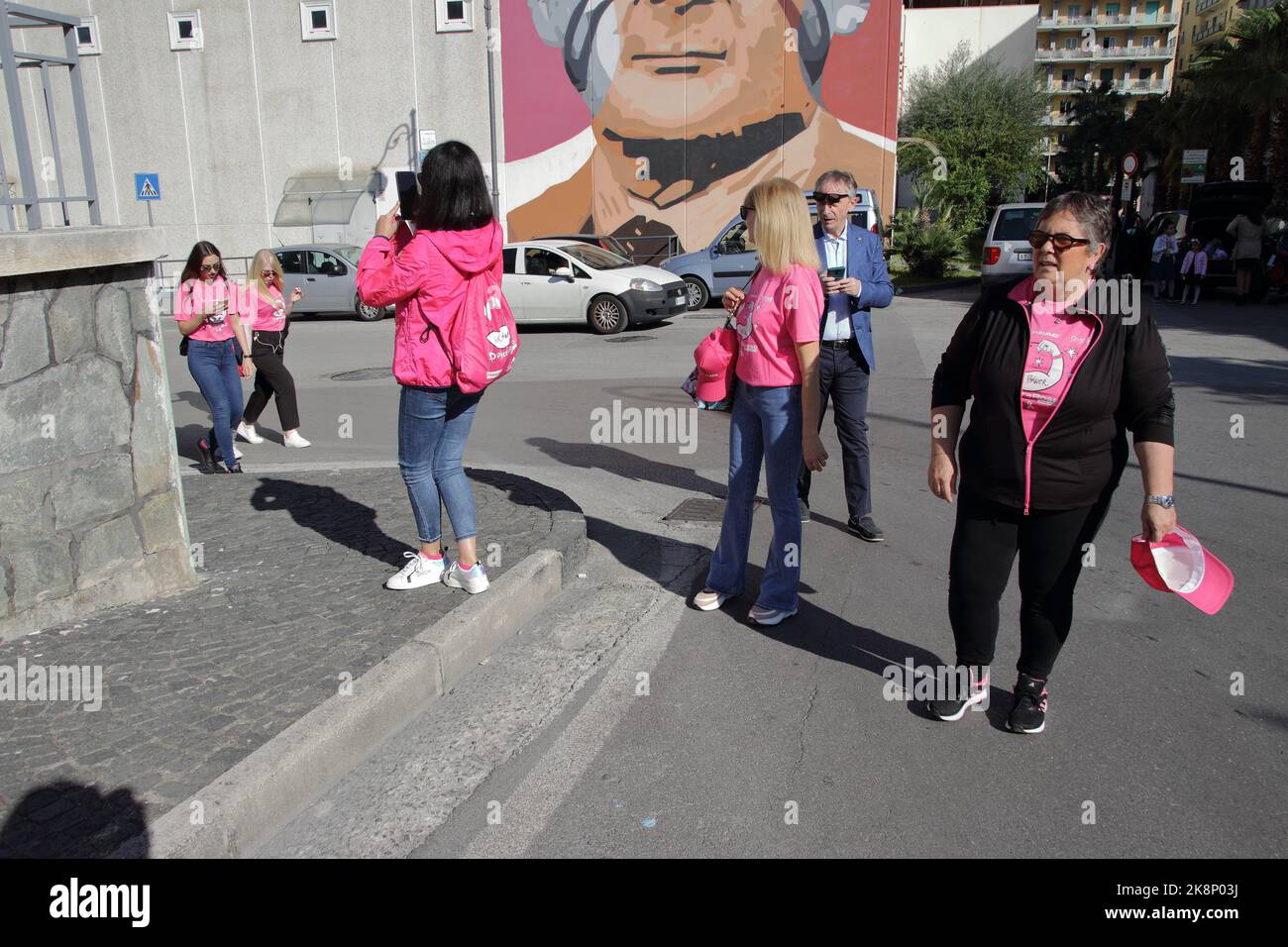 Women with pink T-shirt and hat march through the city on the day of ...