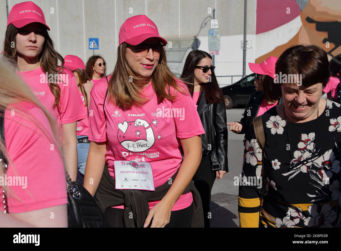 Women with pink T-shirt and hat march through the city on the day of ...