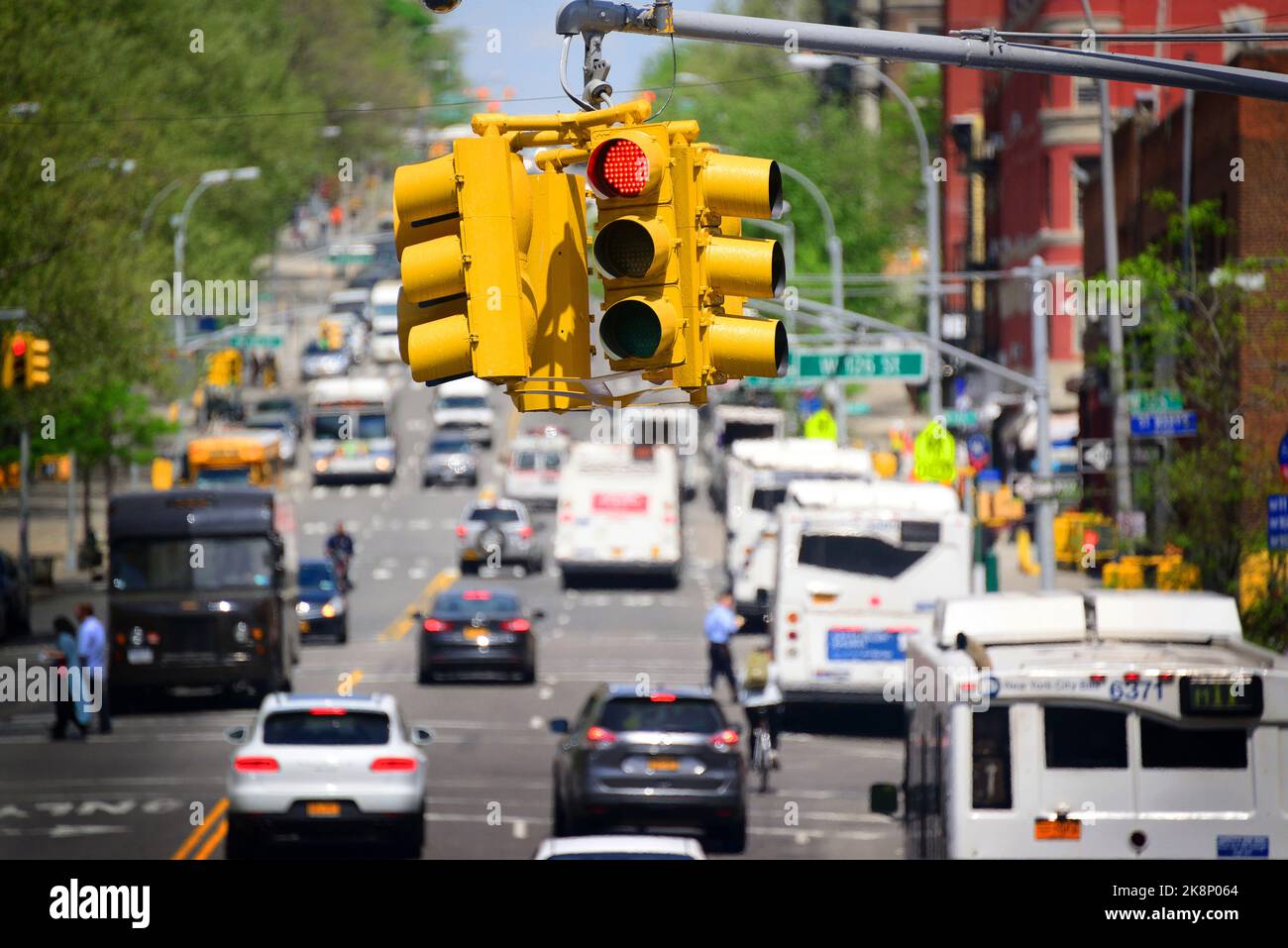 The hanging yellow traffic lights over a busy street in New York, USA ...