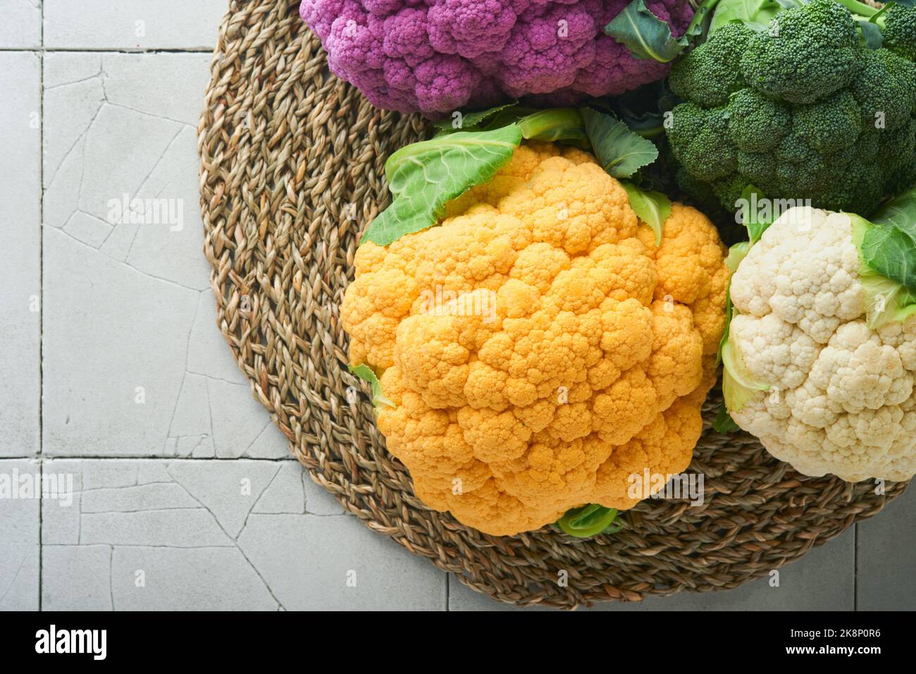 Colorfu cauliflower. Various sort of cauliflower on stone tiles gray ...