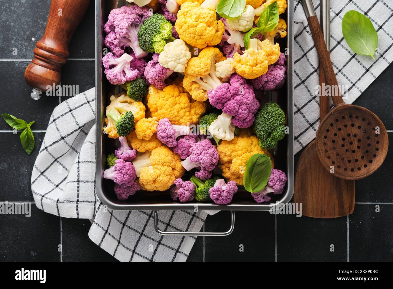 Colorful cauliflower. Cauliflower cut into small pieces in iron pan on ...