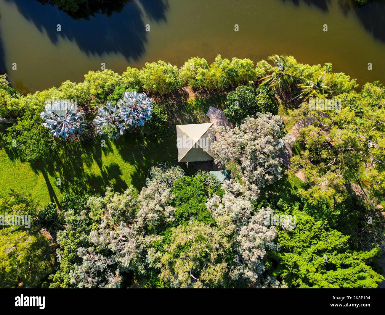 Aerial downward shot of tropical hut next to the river in Cairns ...