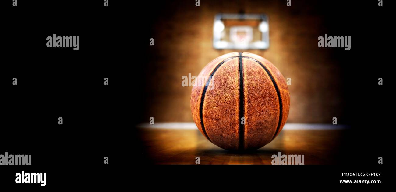 Basketball court with ball hoops rims hardwood floor and lights for ...