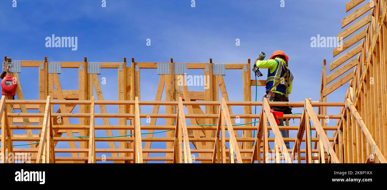 Construction workers working on new home or restidential building with ...