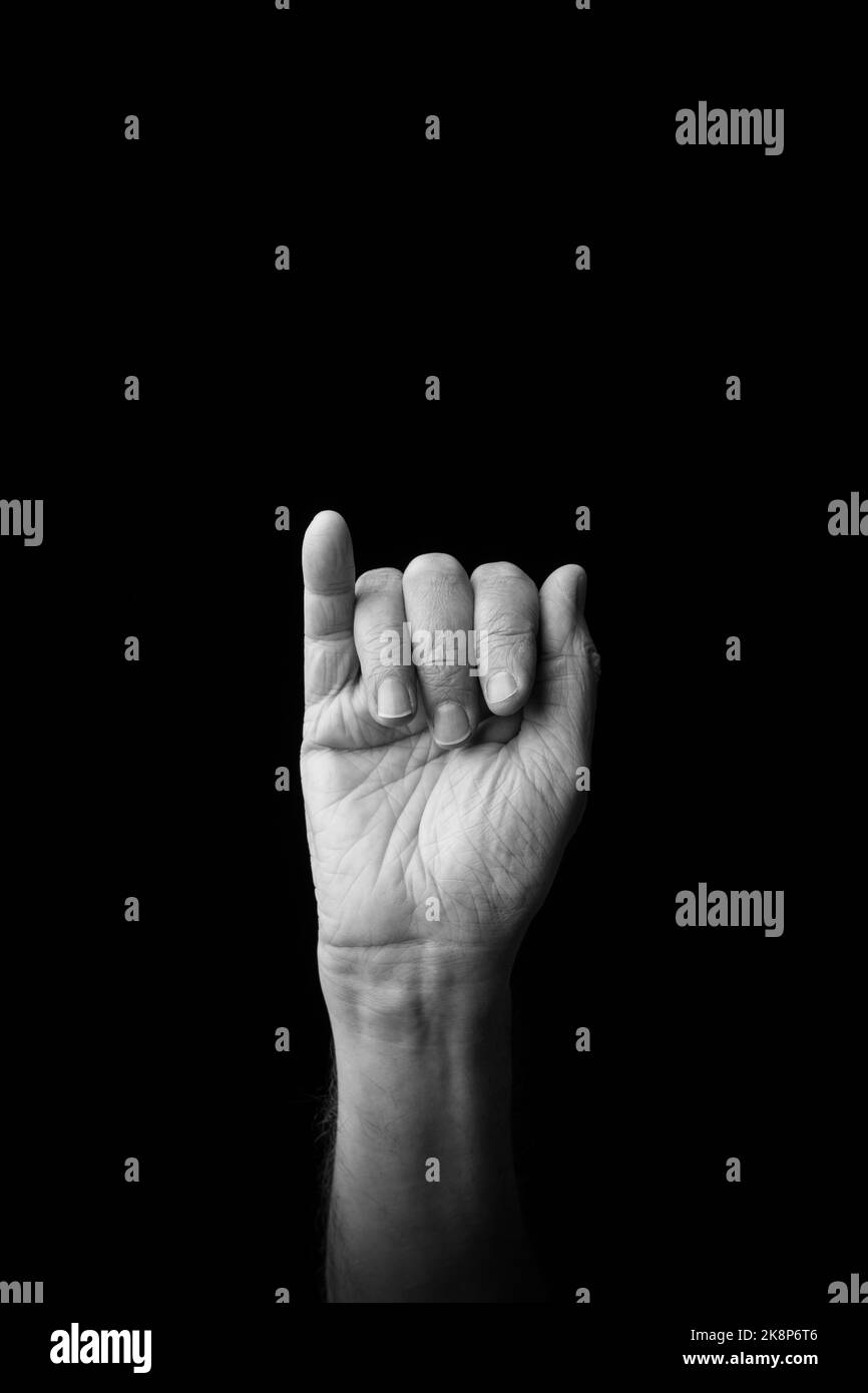 Dramatic black and white image of a male hand fingerspelling the ...