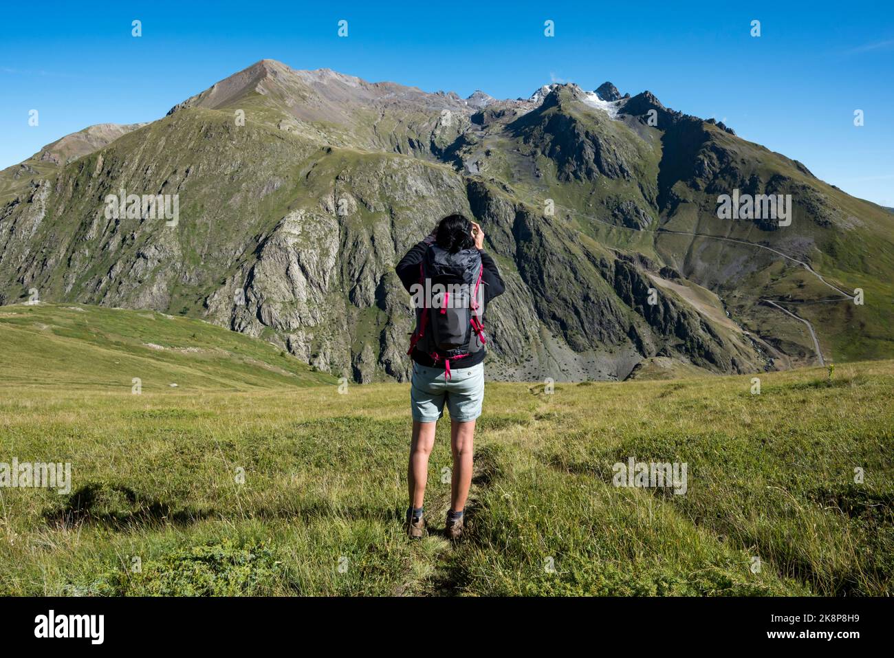 Hiker taking picture of a hill in the french alps, summer vacation ...