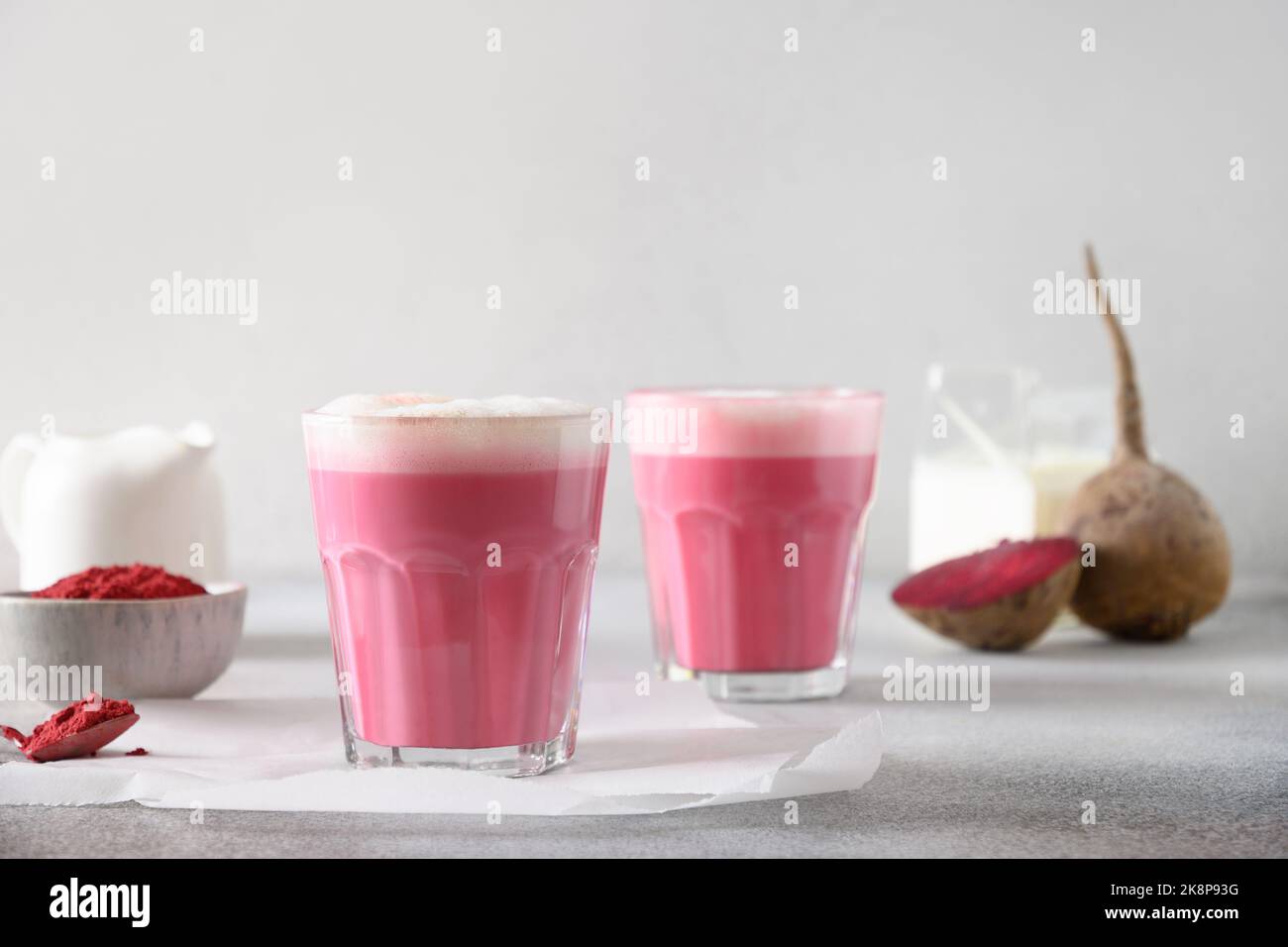 Beetroot latte of beetroot powder and vegan milk on gray background ...