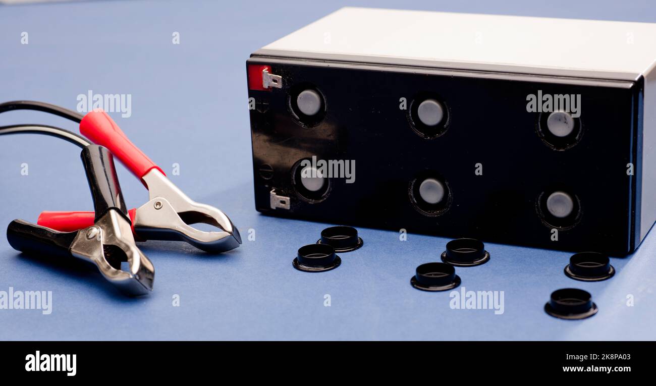 battery maintenance concept, red and black connection pins with battery ...