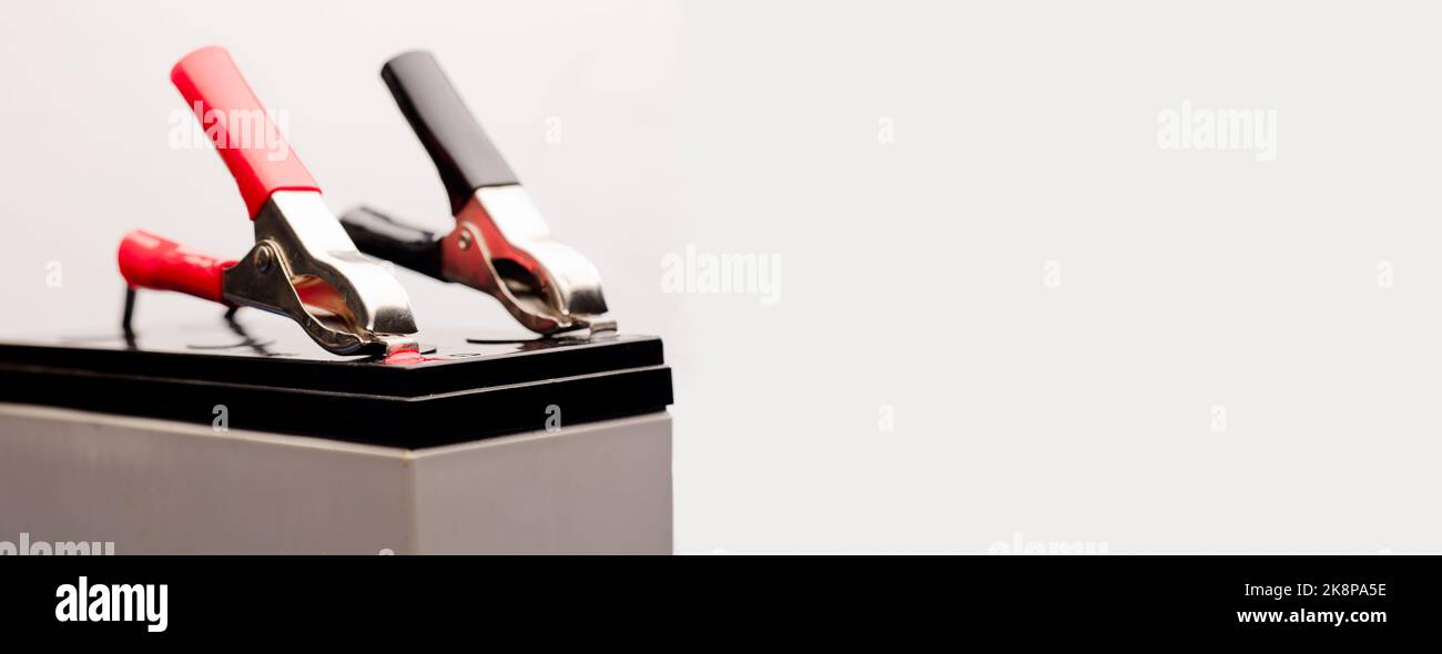 connected bolts charging battery positive pole and negative pole, white ...