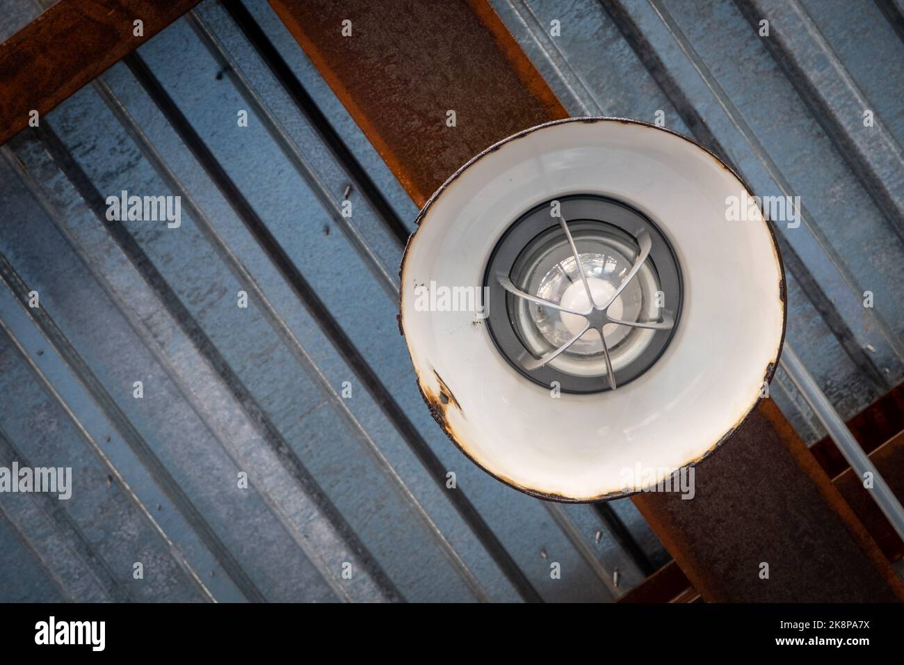Old electric light and damaged enamelled frame Stock Photo - Alamy
