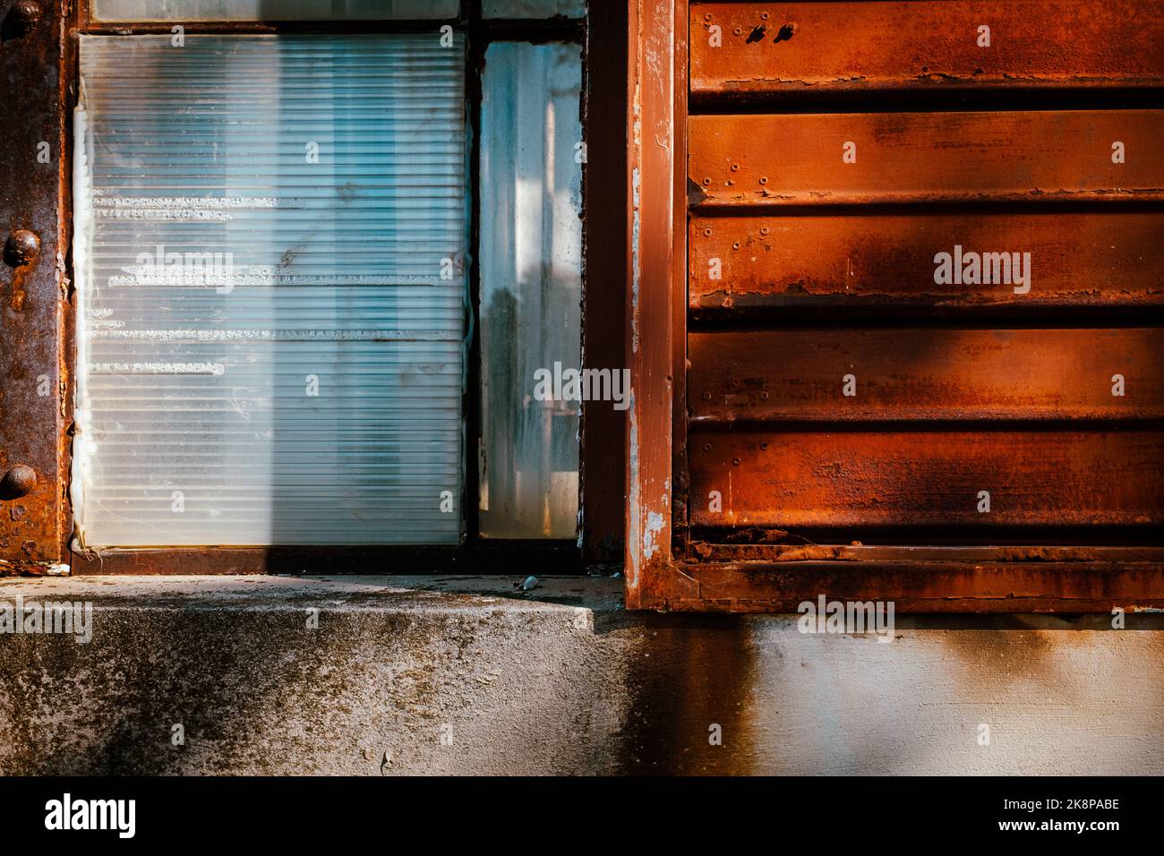 Dirty indutrial window with rusted metal shutter and concrete Stock ...