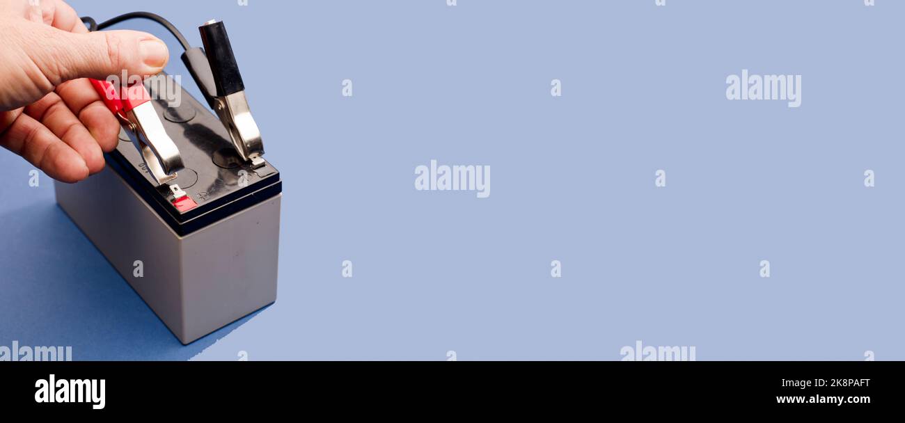 battery bolt in hand of caucasian man, with battery positive pole and ...