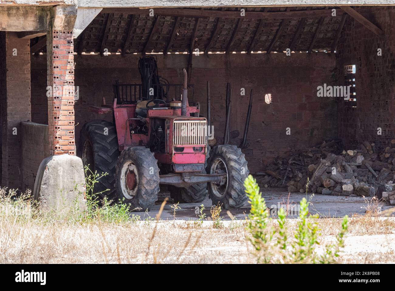 An agricultural tractor parked in a warehouse Stock Photo - Alamy