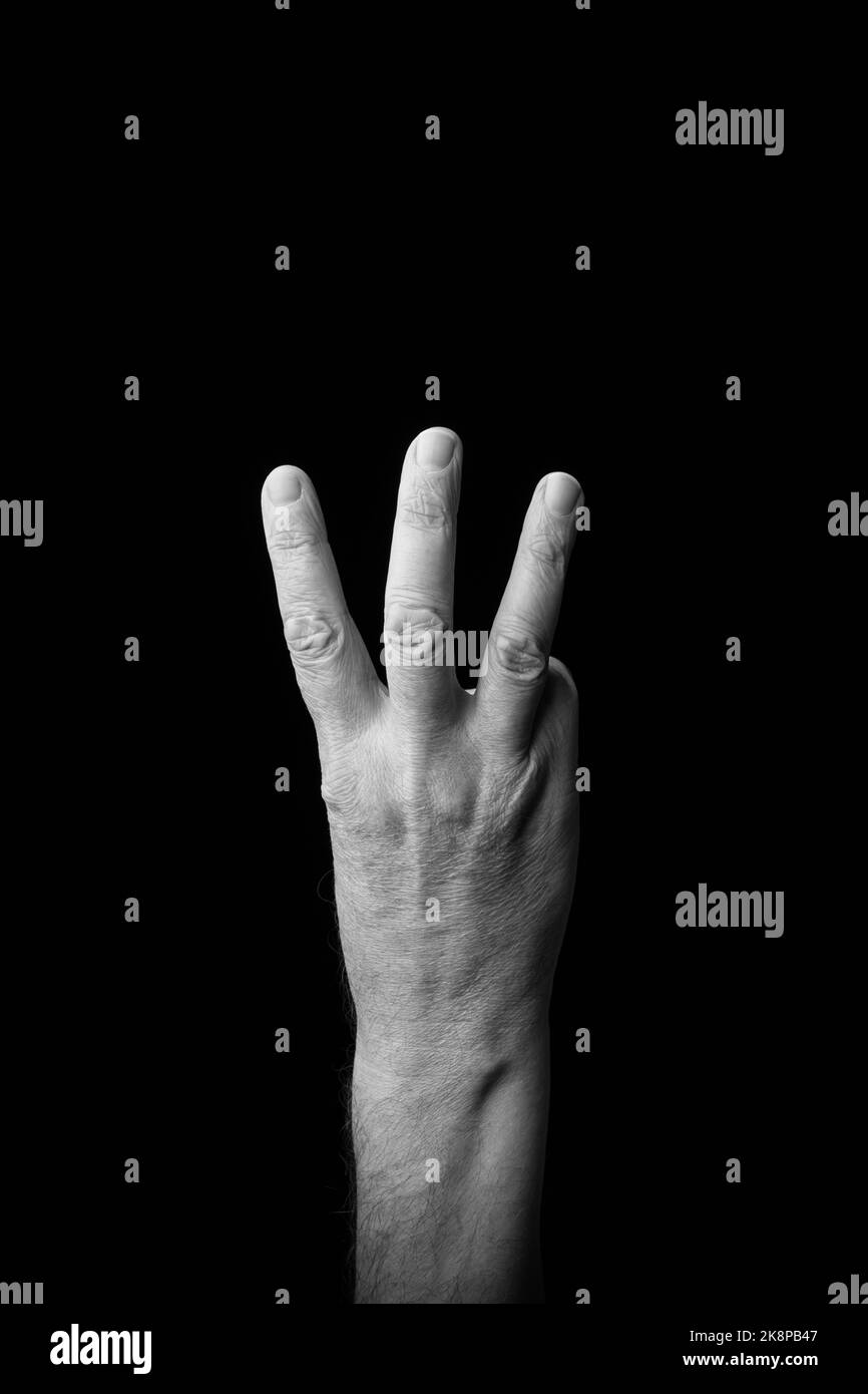 Dramatic black and white image of a male hand fingerspelling the ...