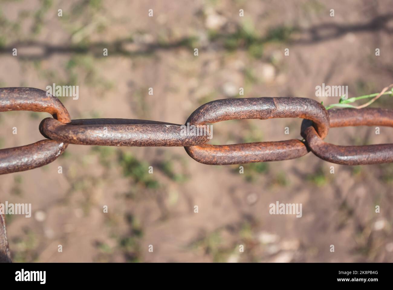 Old rusty chain on the field on ground background Stock Photo - Alamy