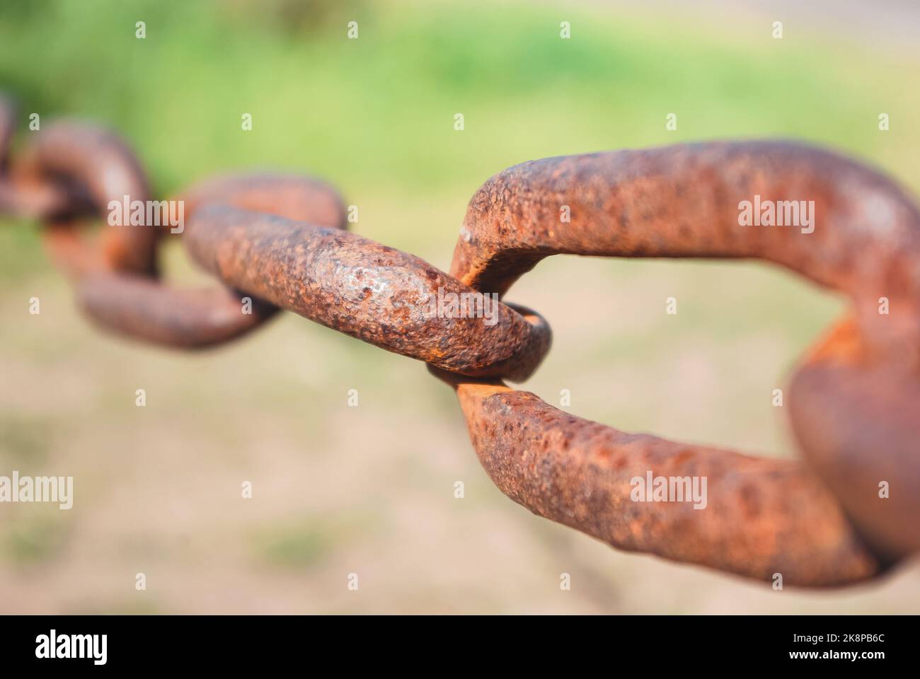 Old rusty chain on the field on ground background Stock Photo - Alamy