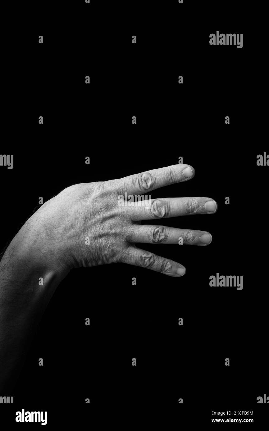 Dramatic black and white image of a male hand fingerspelling the ...