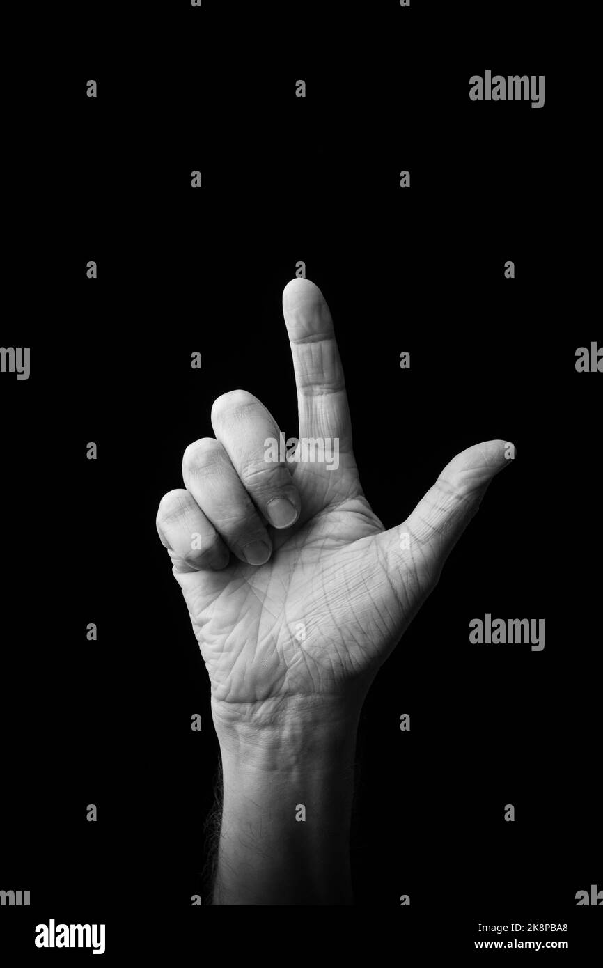 Dramatic black and white image of a male hand fingerspelling the ...