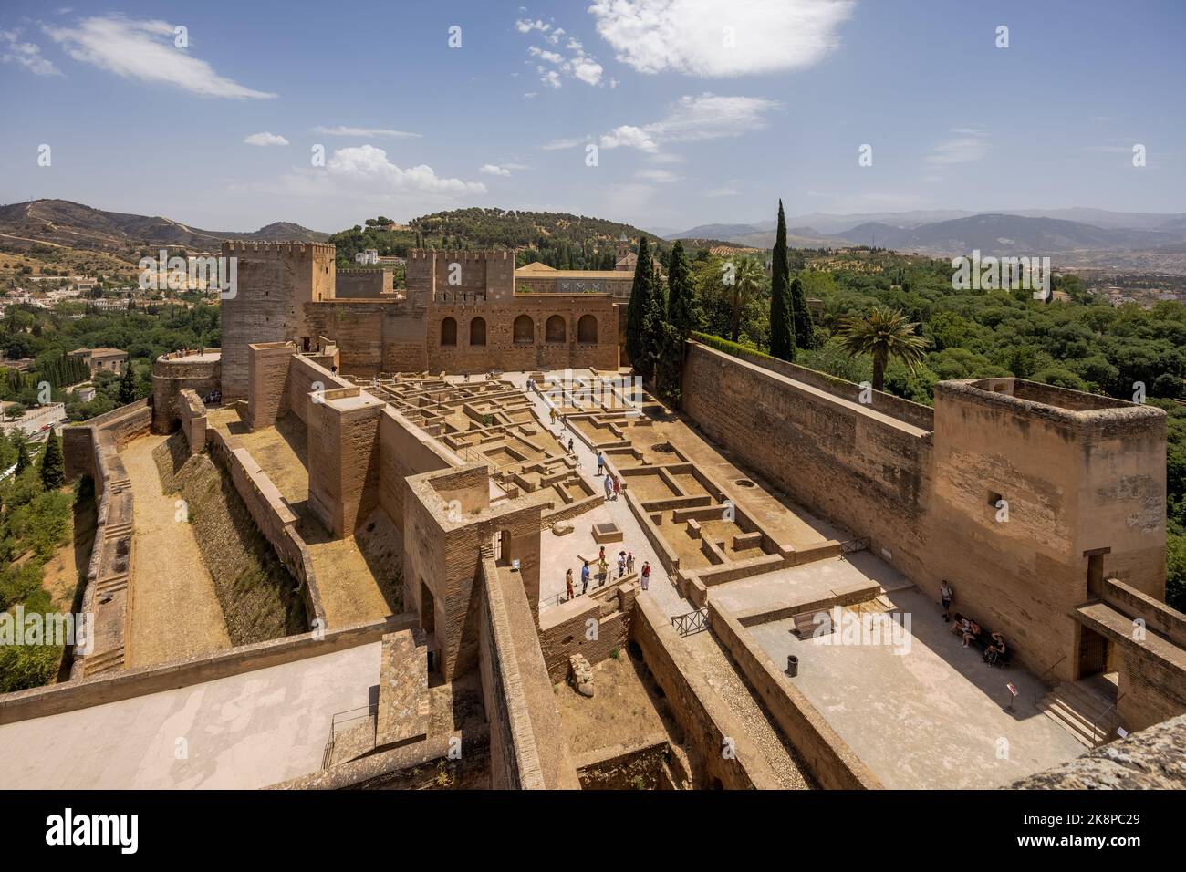 The medieval fortress Alcazaba full of tourists under a blue sky ...