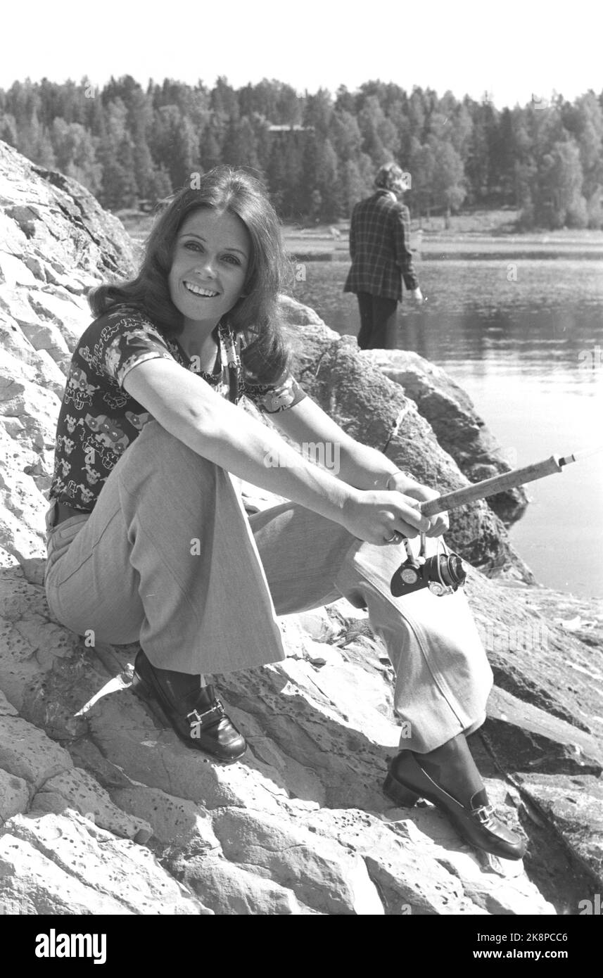 Wenche tries the fishing luck outside his home photo hi-res stock ...