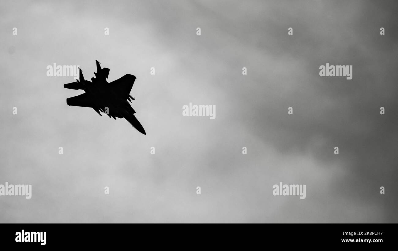A grayscale of an aircraft in a cloudy sky Stock Photo - Alamy