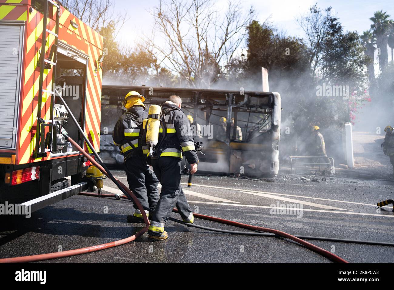 Rescue Team of Firefighters Arrive on the Car Crash fired passenger bus ...