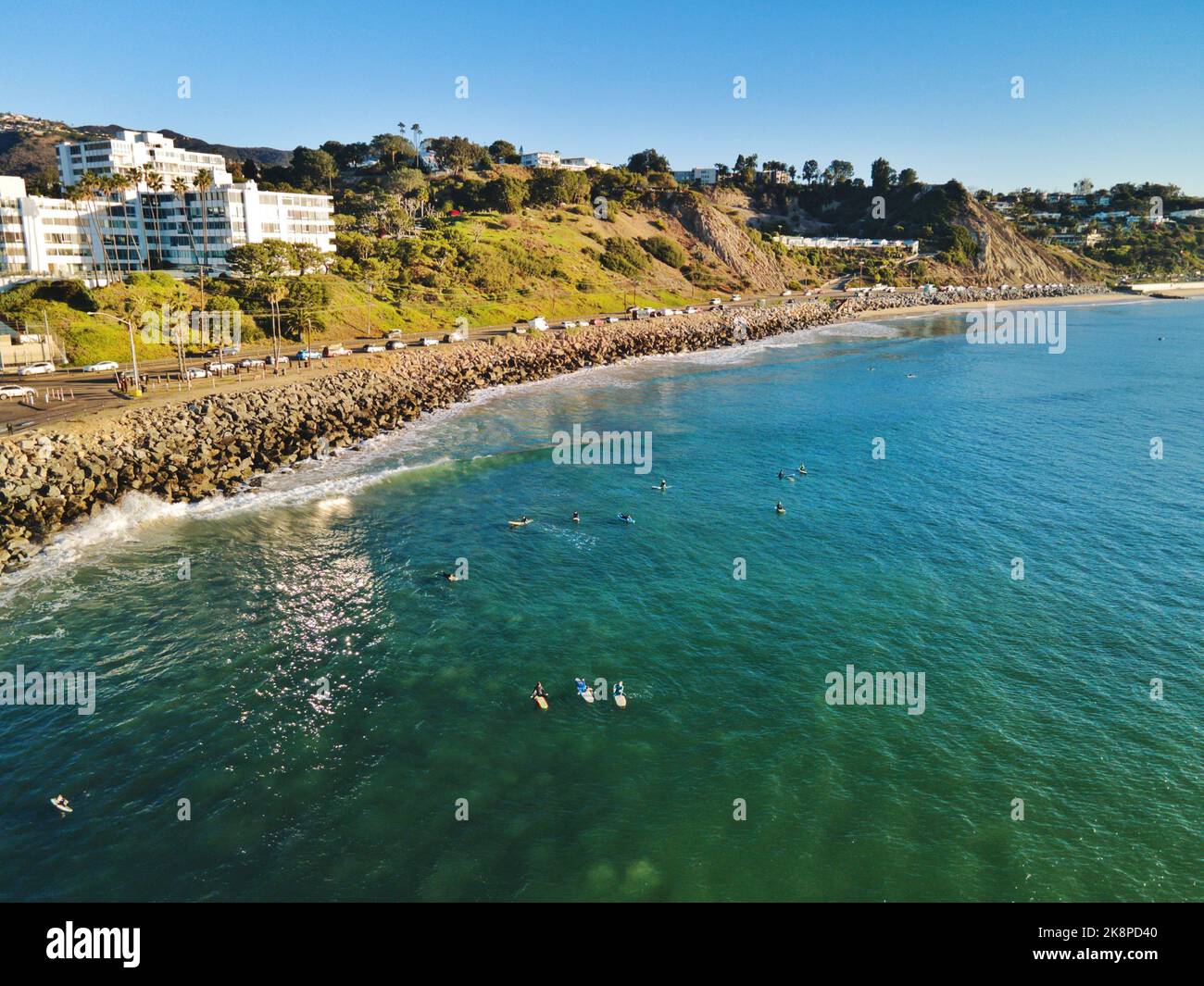 An aerial view of the sea with floating boats and coastline buildings ...