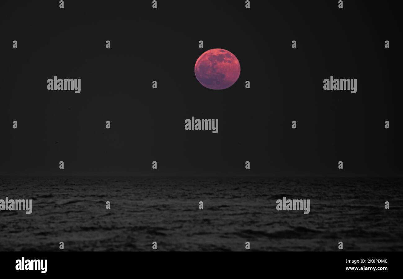 An aerial view of seascape under colorful full moon in night Stock ...