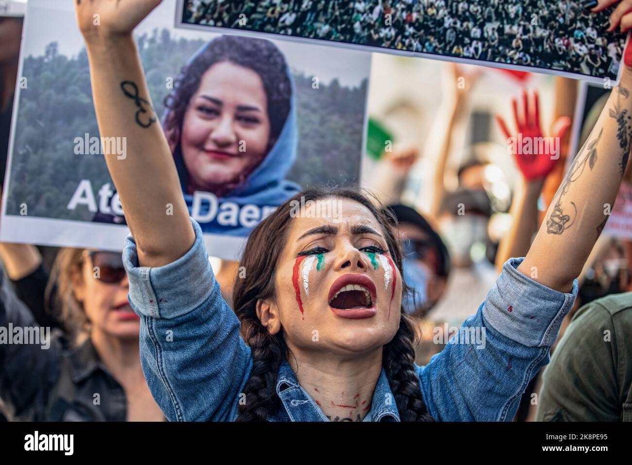 Istanbul, Turkey. 24th Oct, 2022. A protester with paintings of Iranian ...