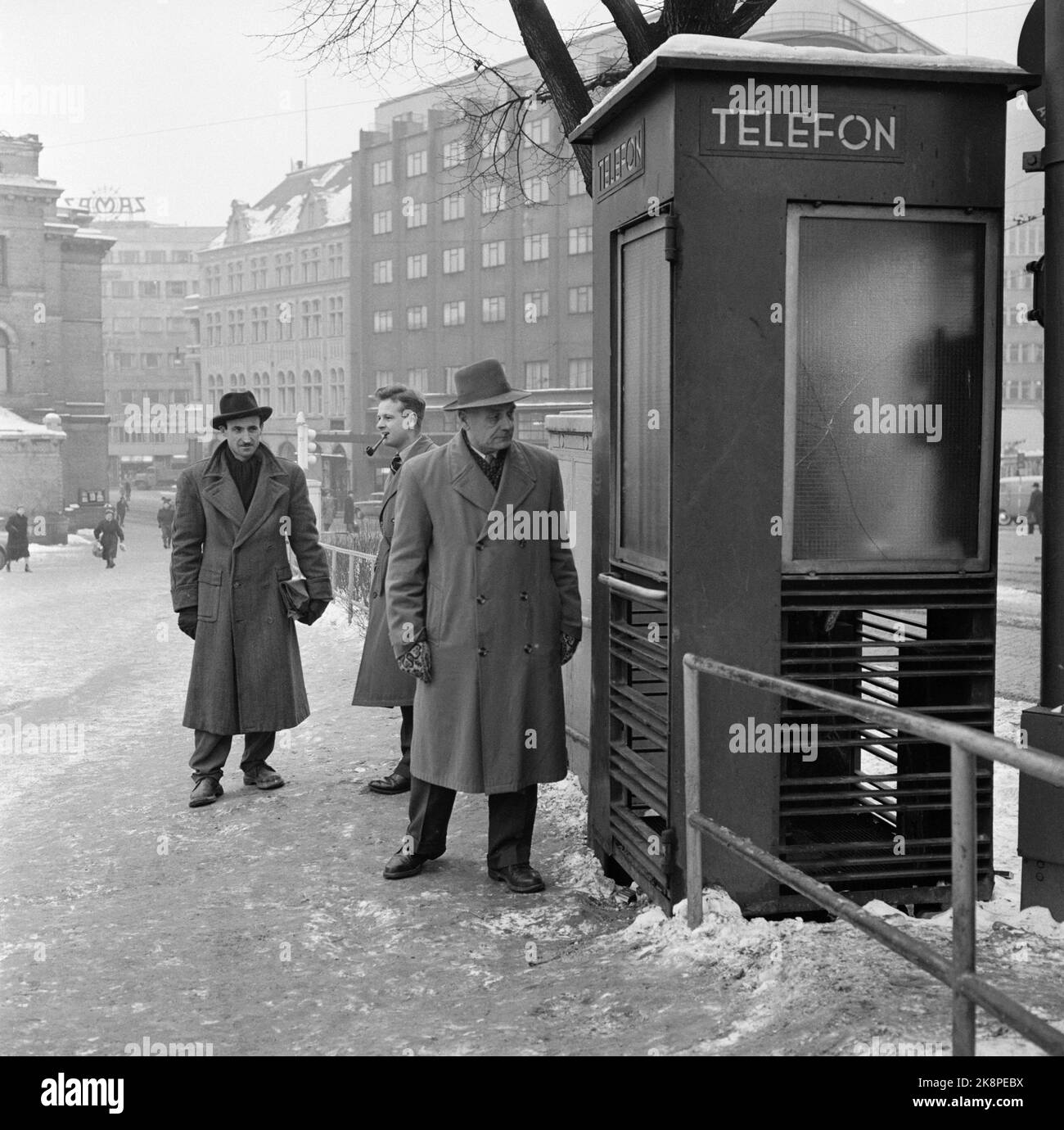 Oslo 1956. Three men are in line waiting to use the telephone booth at ...