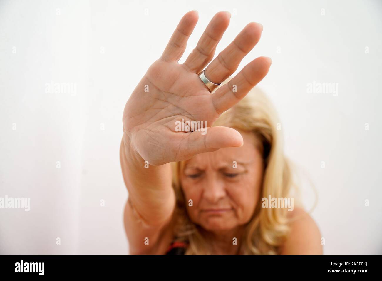 Unhappy and sad lonely woman covers her face with her hands ...