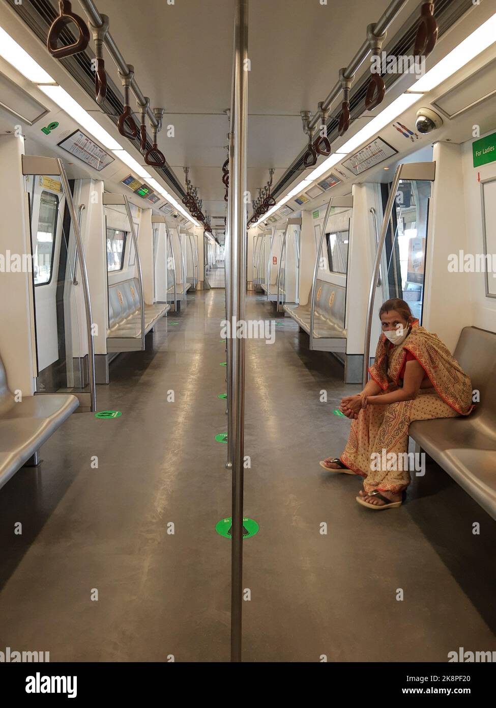 A vertical shot of a female wearing a mask while travelling on metro ...