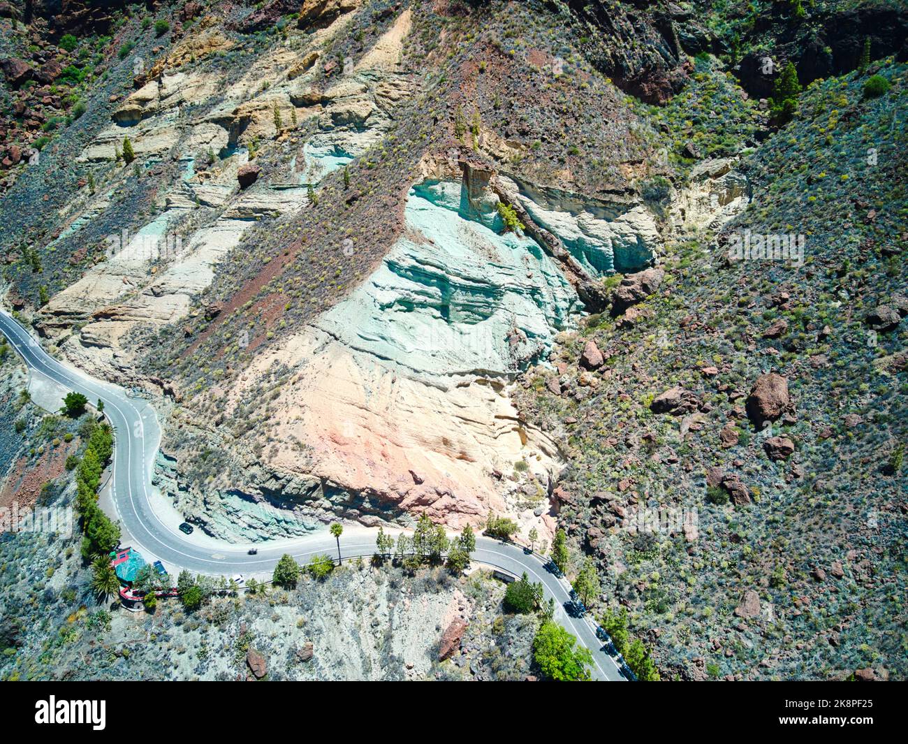 An aerial of cars driving on the Los Azulejos De Veneguera, Rainbow ...