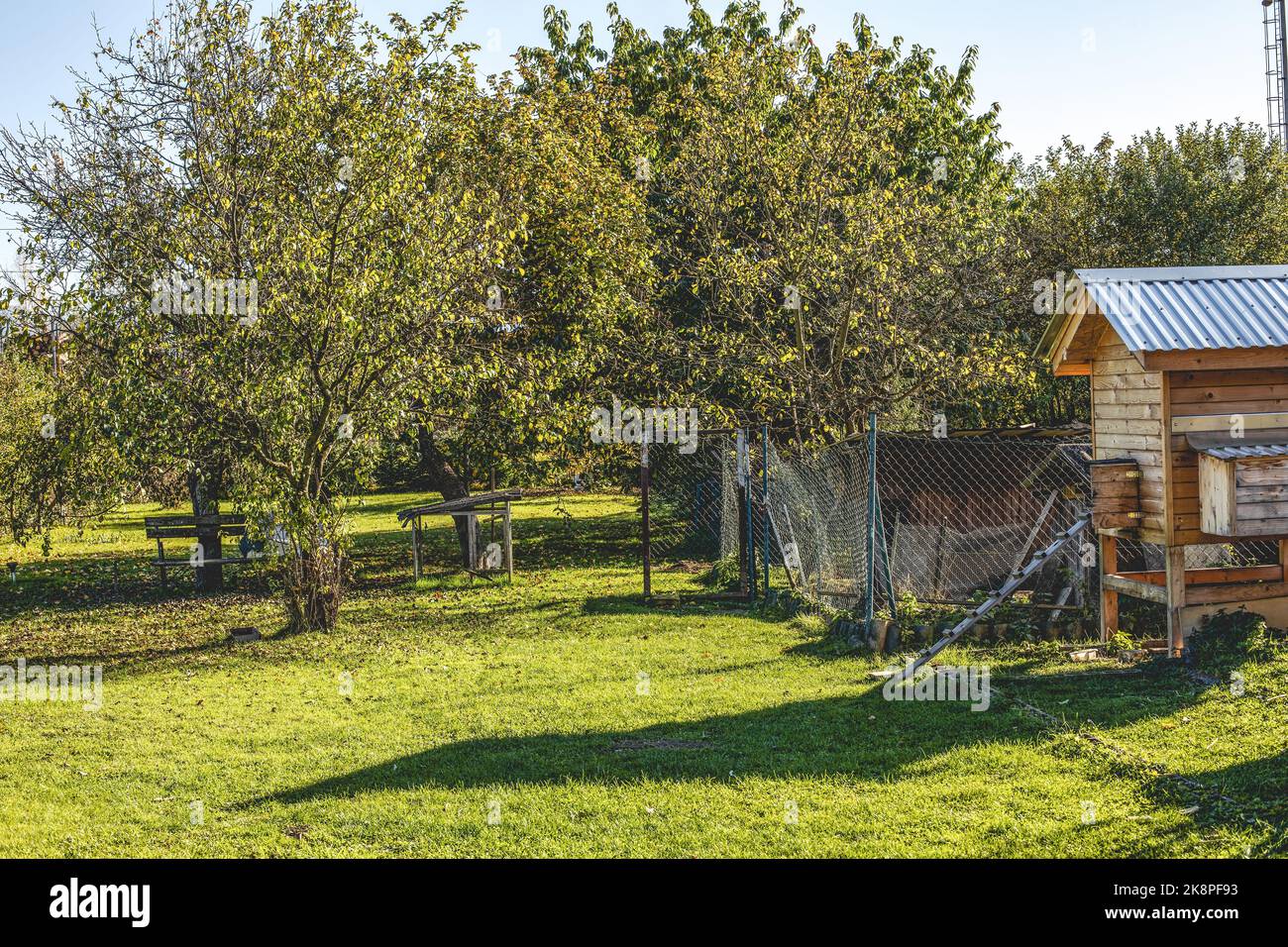 Hen coop in the garden.Trees blooming in background.Spring season. High ...