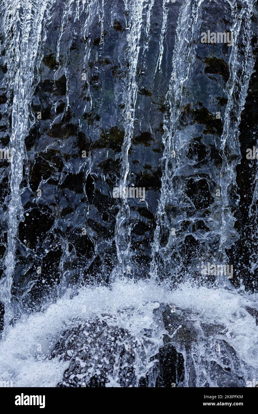 The flow of clean water in the waterfall, close-up, vertical background ...